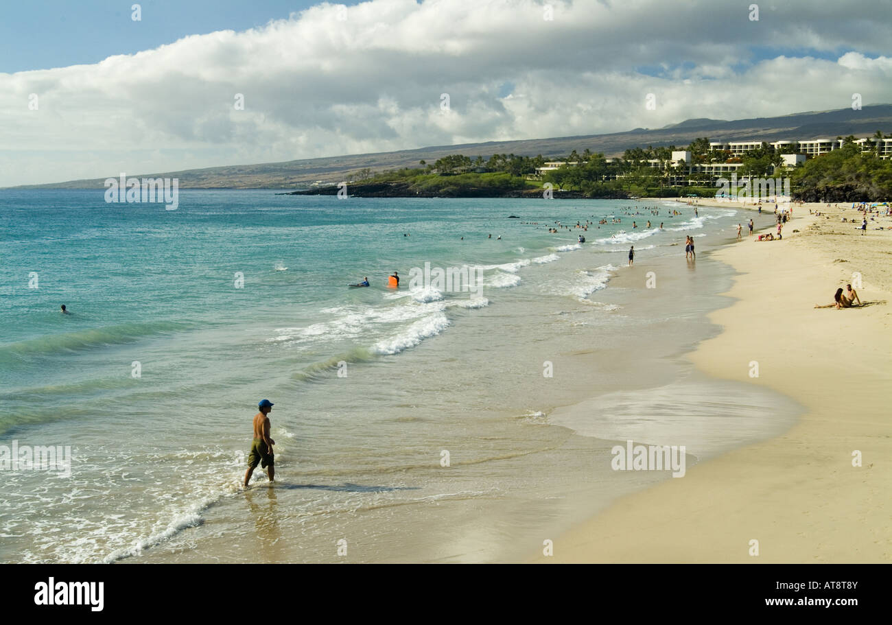 Tourists enjoy the clear blue water and white sand at Hapuna Beach in ...