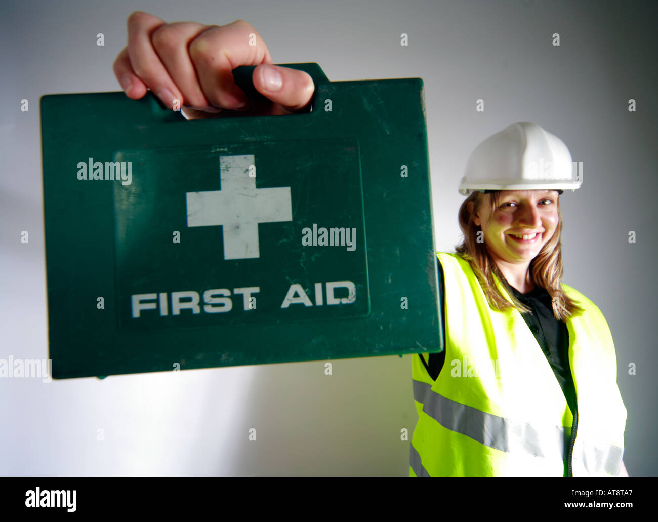 Female construction worker or first aider with a first aid box Stock ...