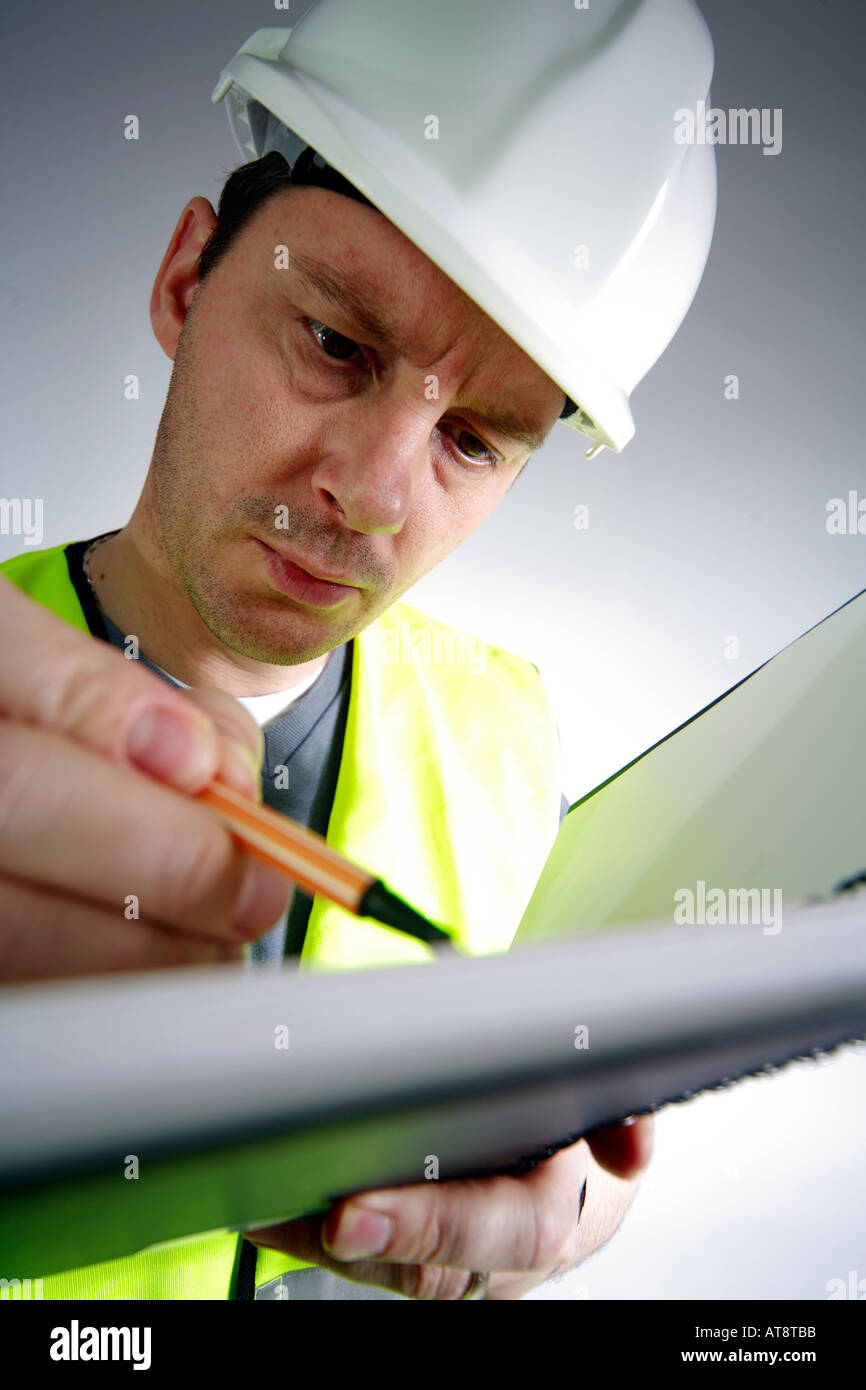 Construction worker or surveyor writing into a notebook Stock Photo - Alamy