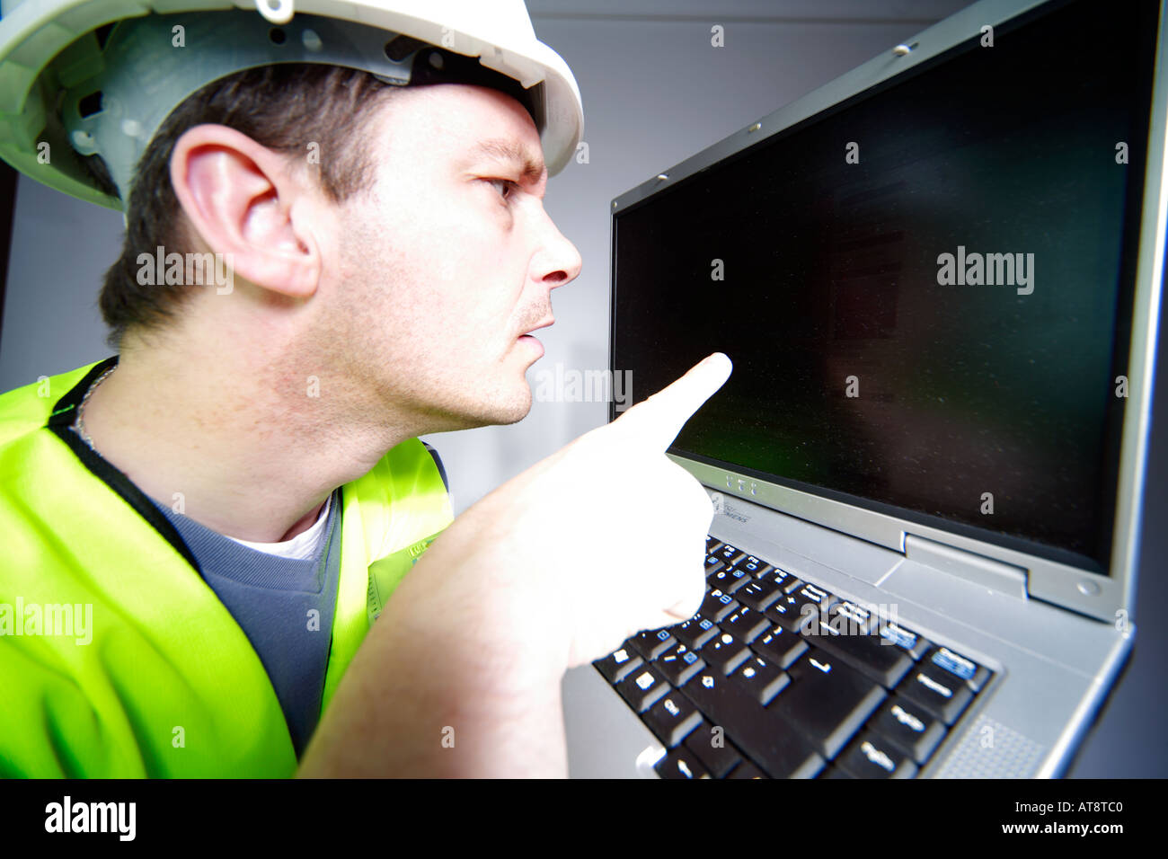 Construction worker or surveyor looking at a notebook computer Stock ...