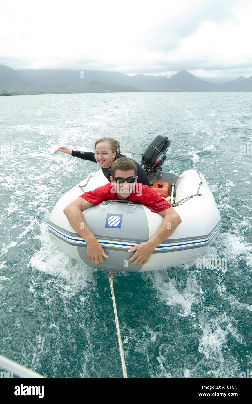 Two teen boys have a blast on a raft pulled by a boat on Kaneohe Bay on ...