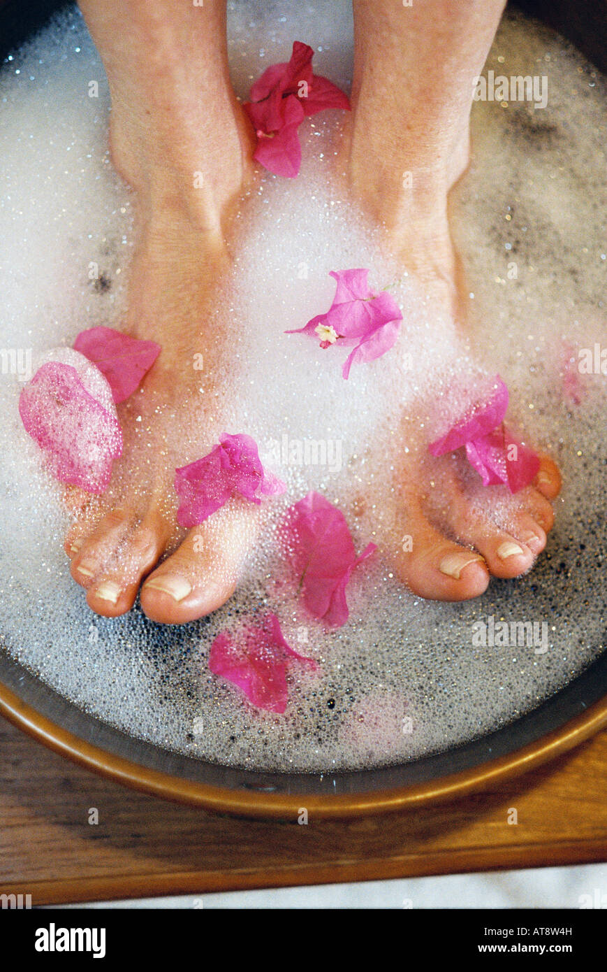 Closeup of bubble foot bath with pink bougainvillea flower petals Stock ...