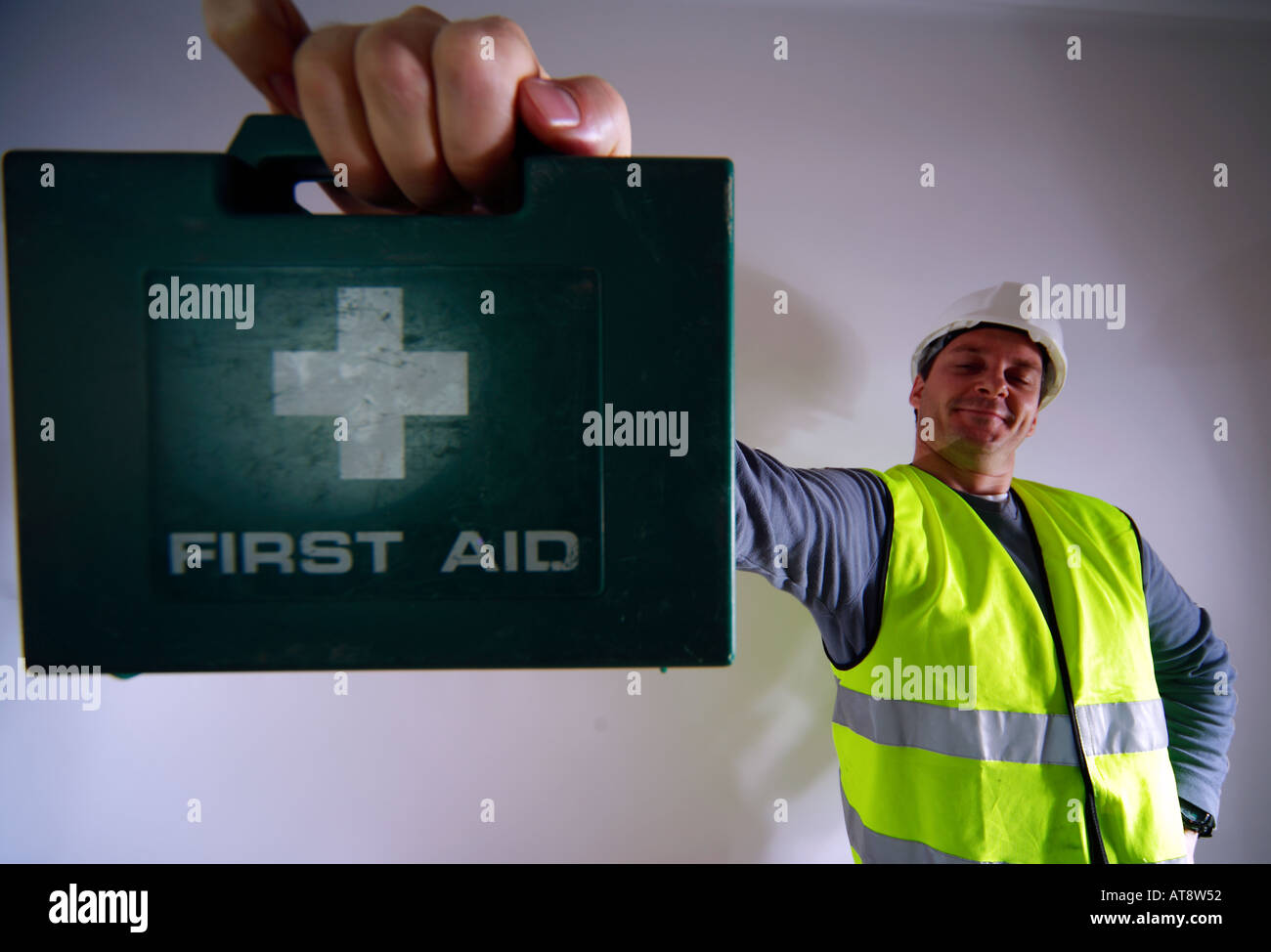 Construction worker holds out a first aid box with pride Stock Photo ...