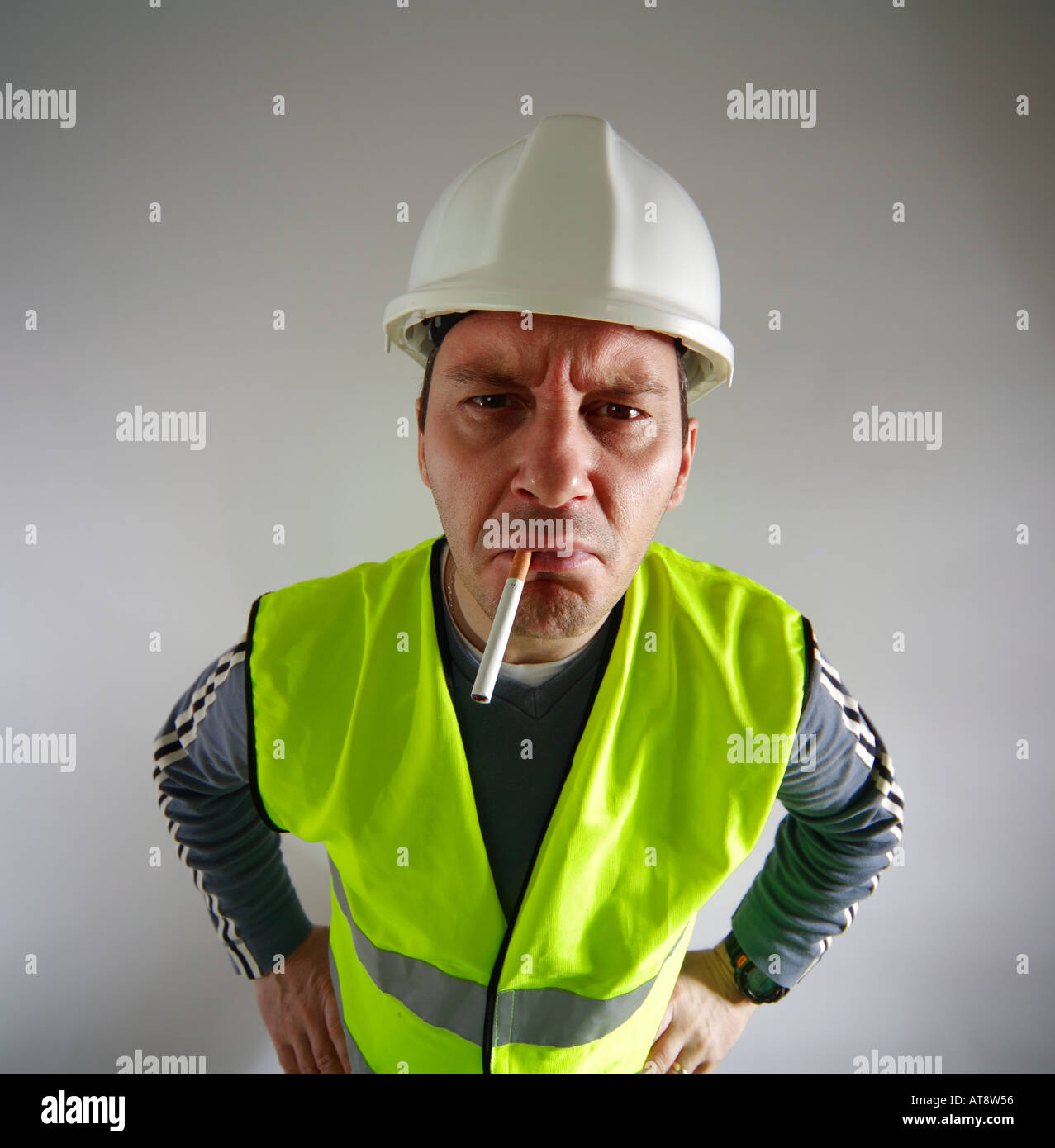 Obstinate looking construction worker with cigarette in his mouth Stock ...
