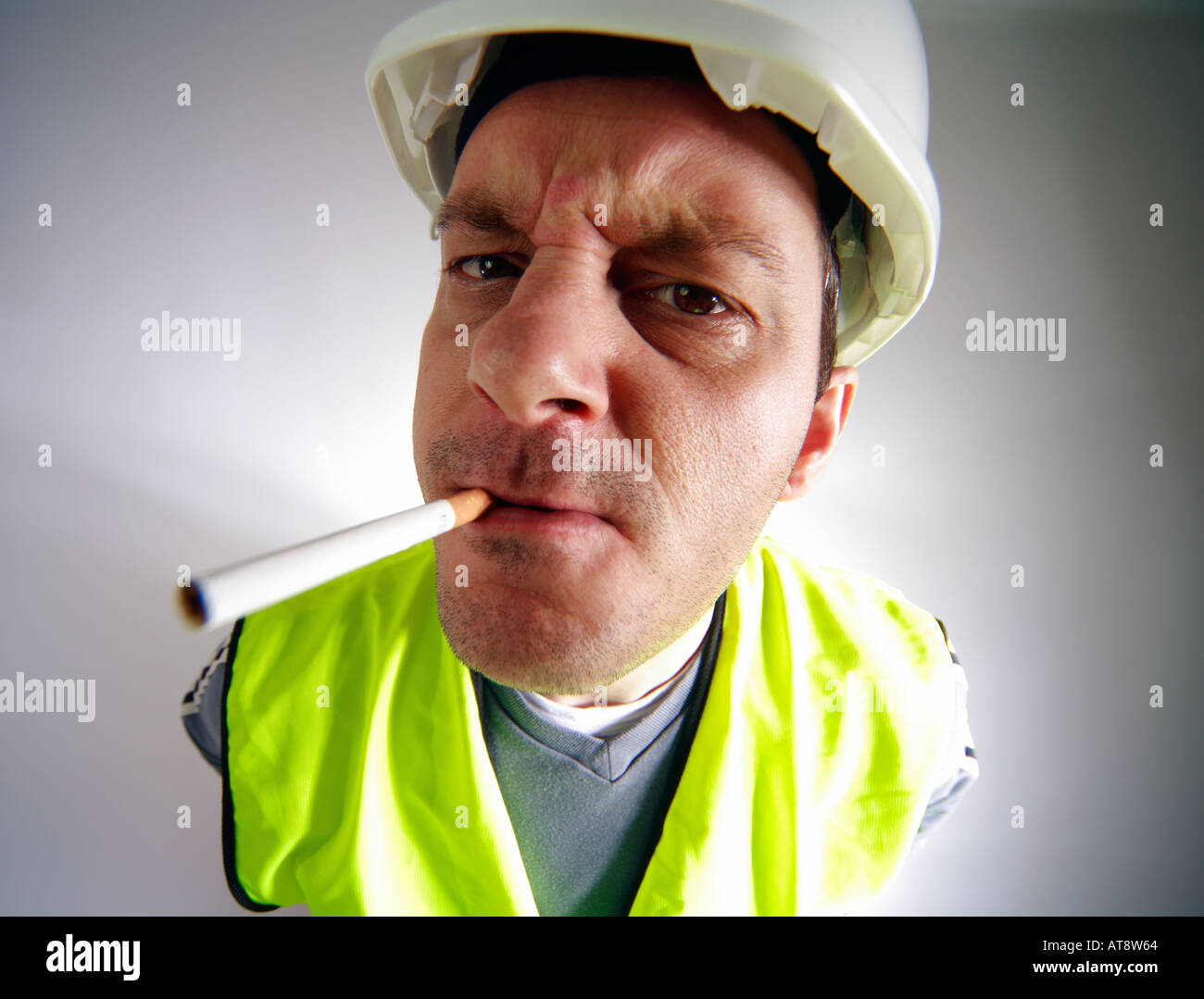 Obstinate looking construction worker with cigarette in his mouth Stock ...