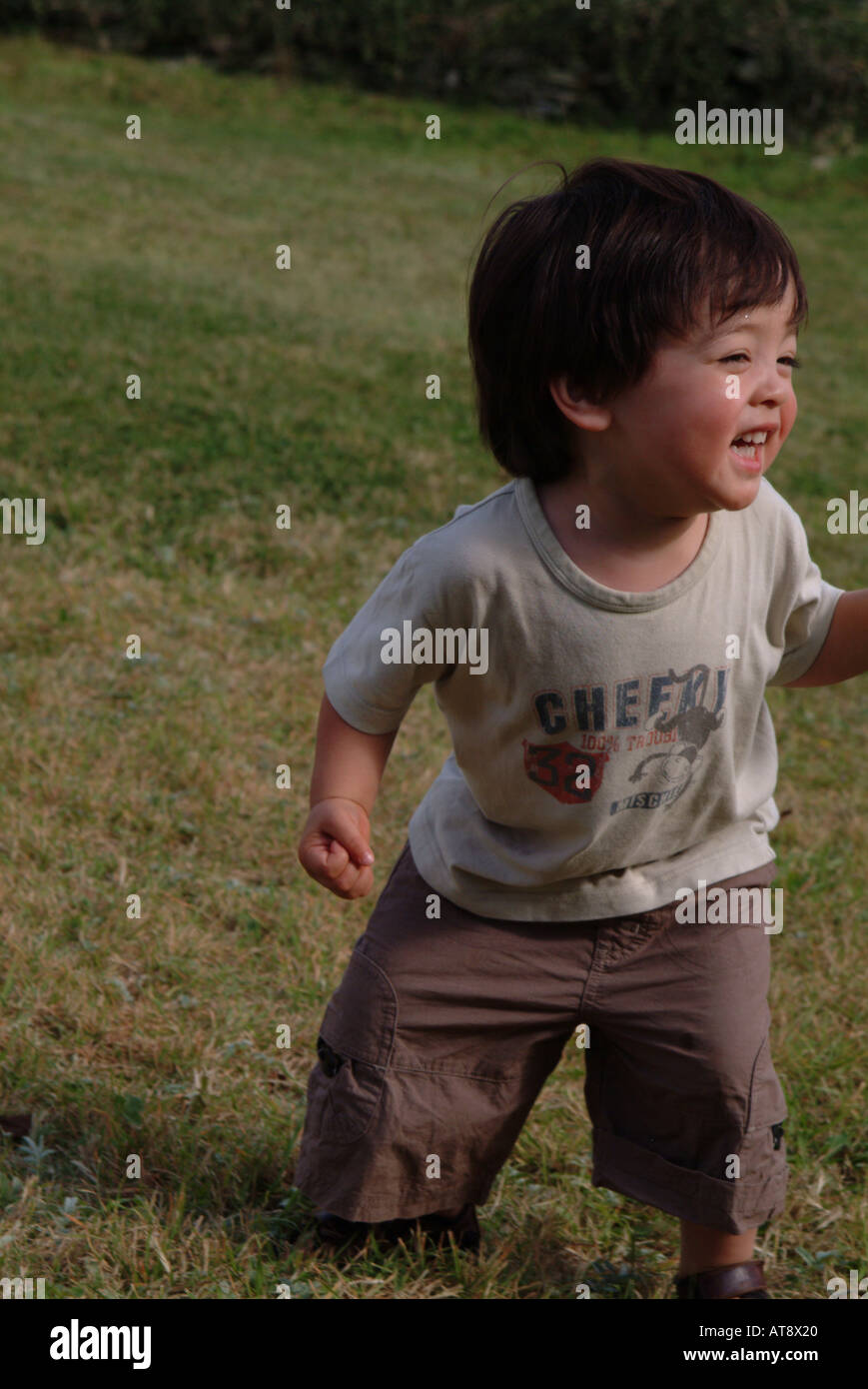 Little boy playing outside Stock Photo - Alamy