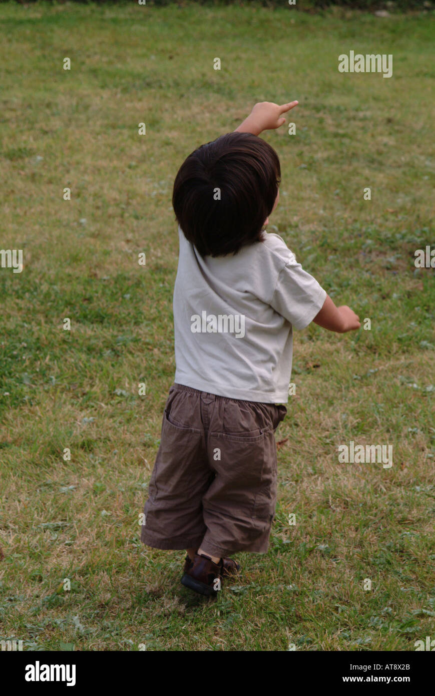 Rear view of a little boy running Stock Photo - Alamy