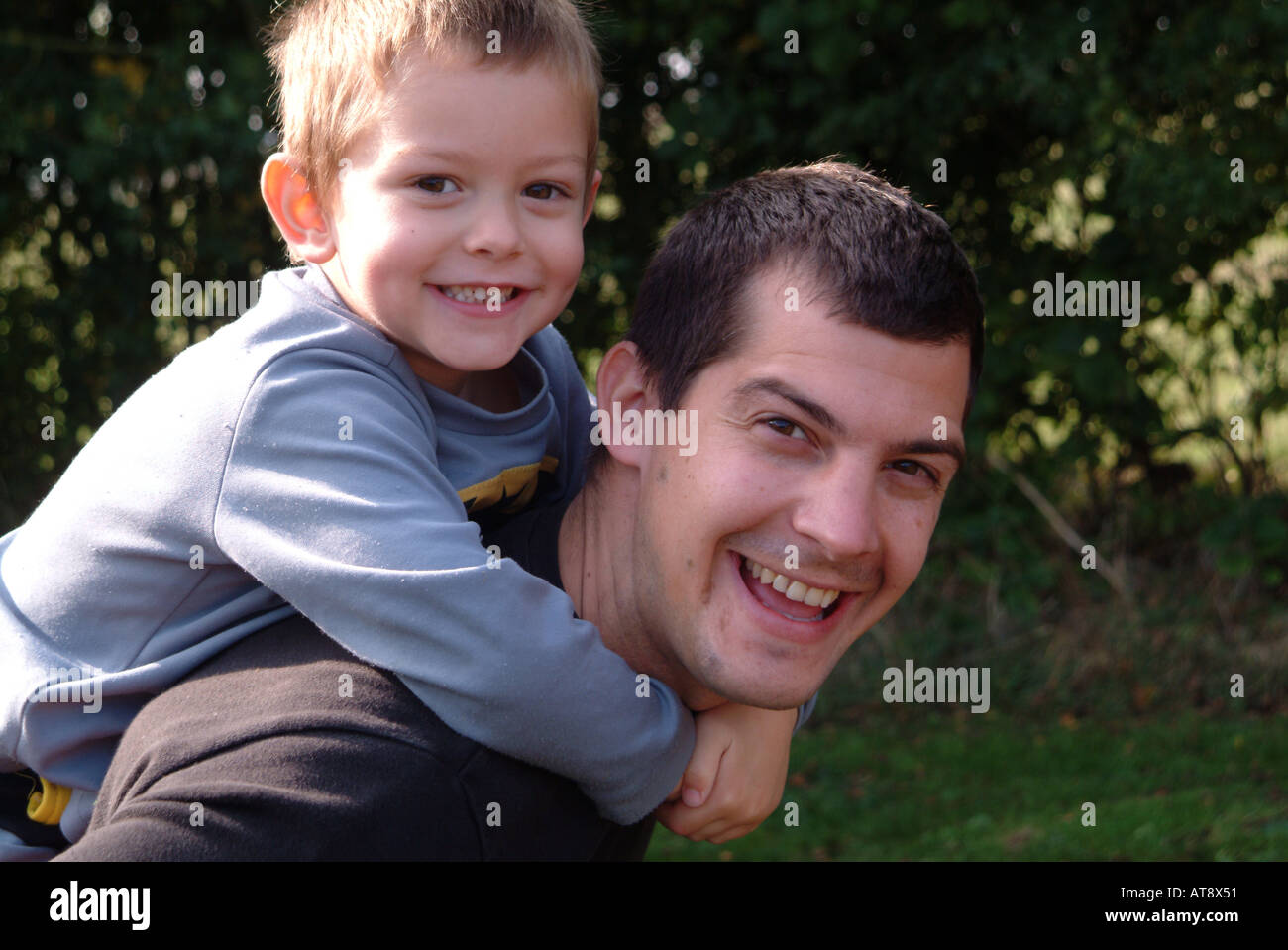 Dad giving his son a [piggyback ride] Stock Photo - Alamy