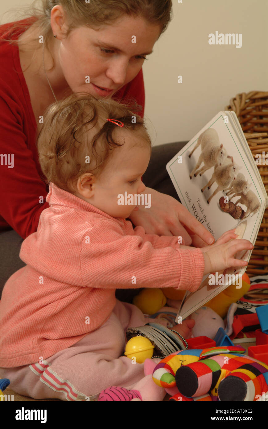 Mother and baby reading a book together Stock Photo - Alamy