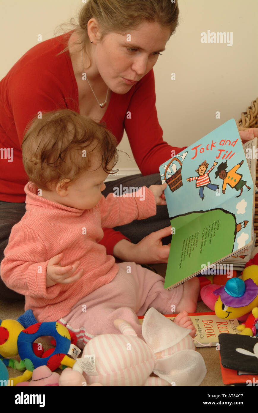 Mother and baby reading a book together Stock Photo - Alamy