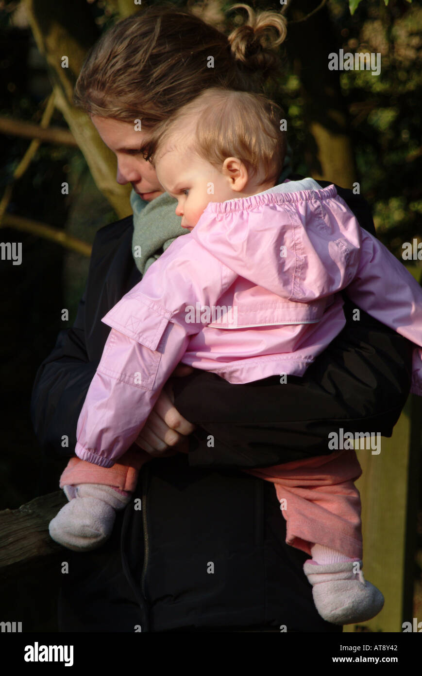 Mother outside walking and carrying a baby Stock Photo - Alamy