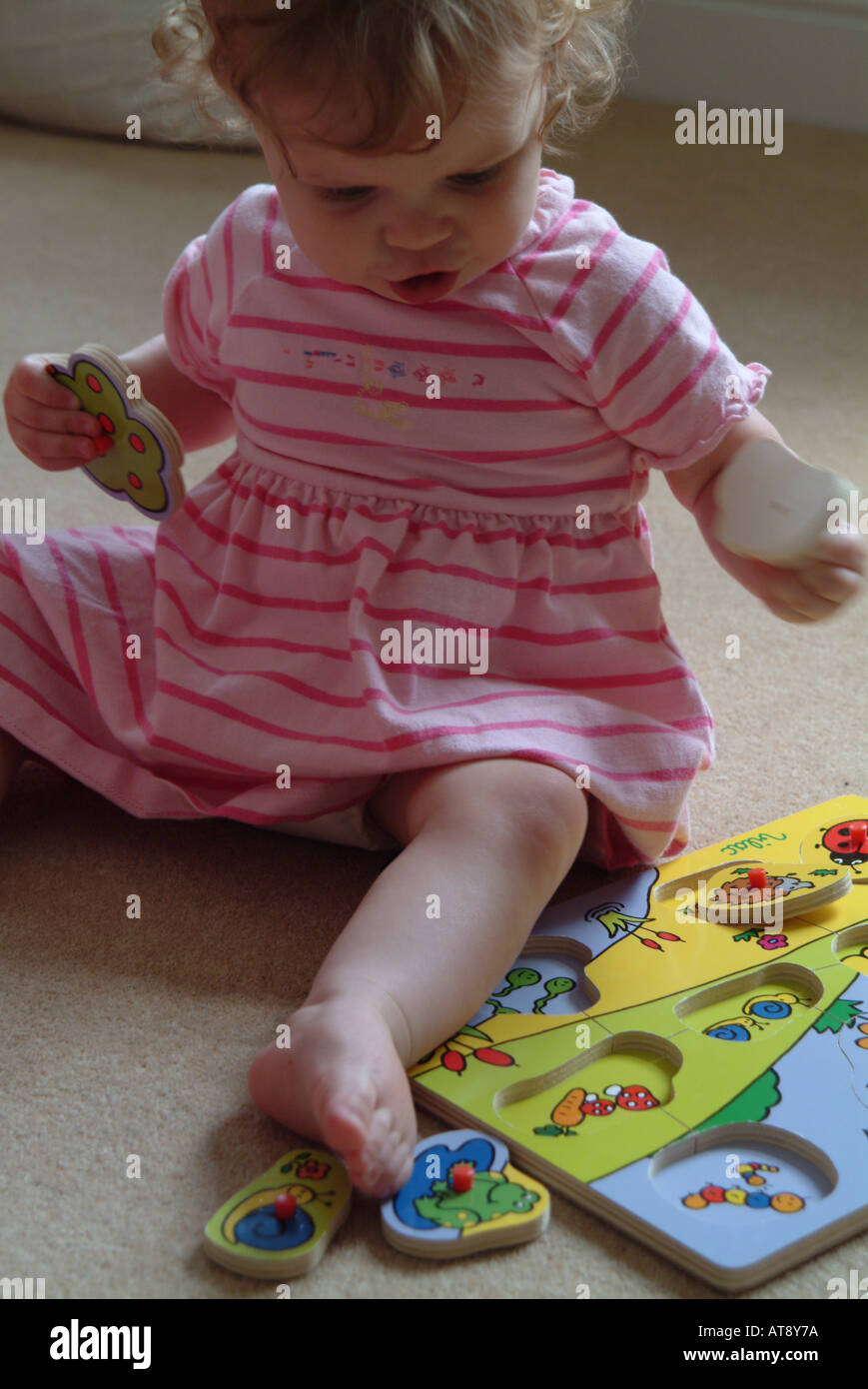 Toddler learning how to do a puzzle Stock Photo - Alamy