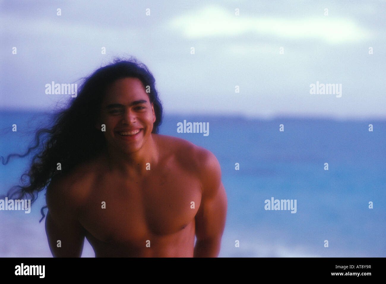 Young Hawaiian man at sunrise on the beach, Oahu Stock Photo - Alamy