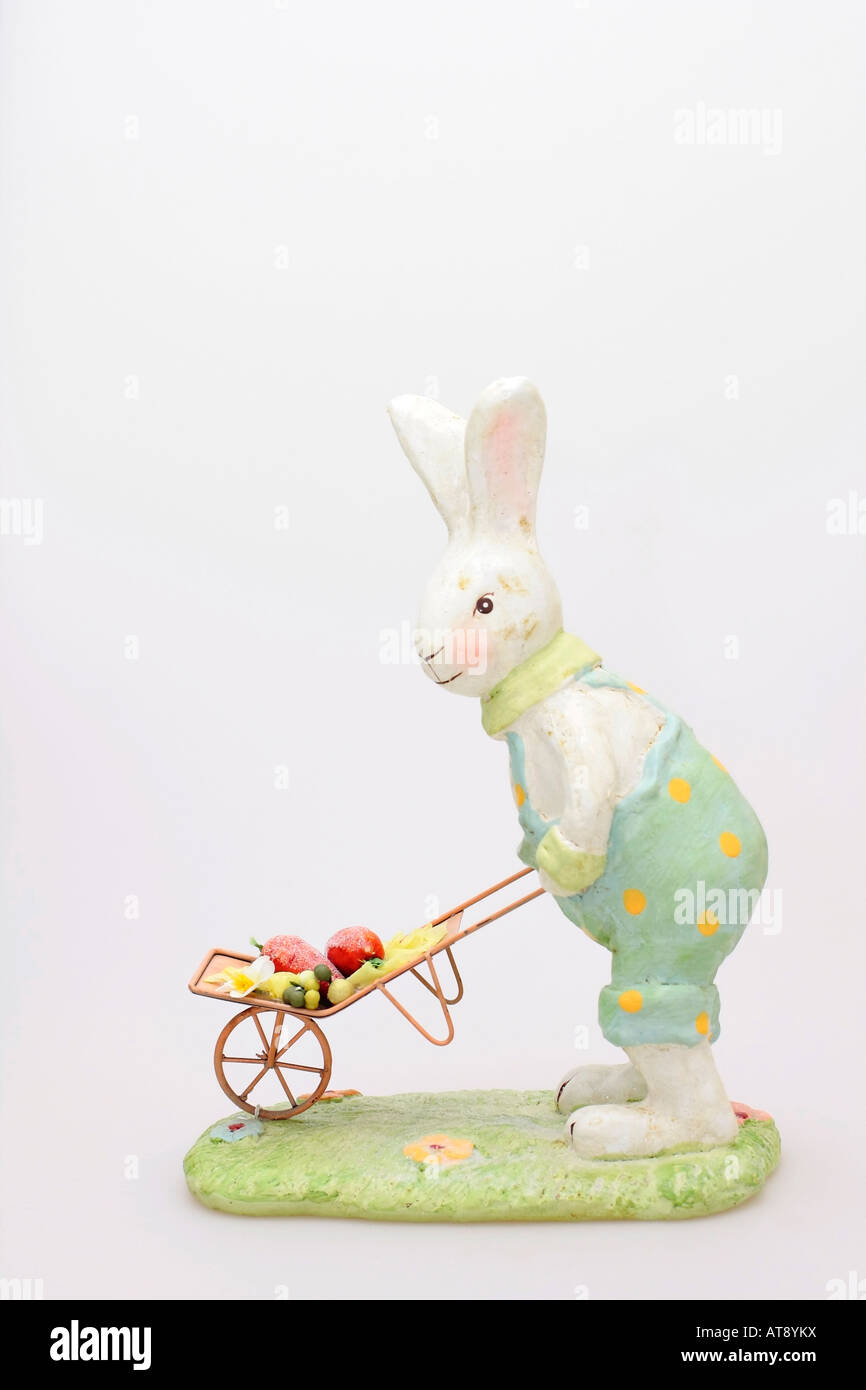 Ceramic bunny rabbit pushing wheelbarrow Stock Photo - Alamy