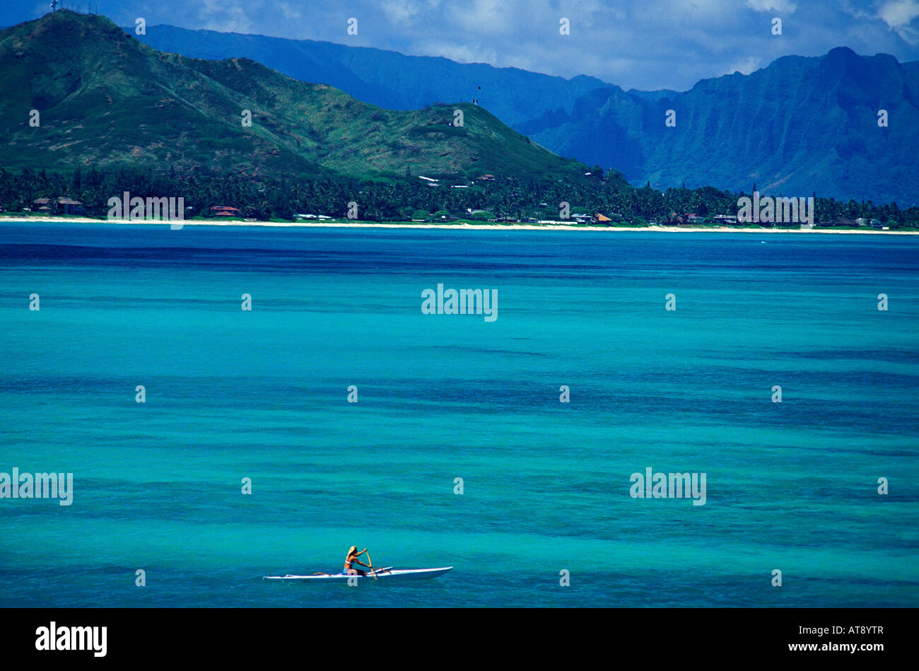 Single kayak out in the blue waters of Kailua bay, on the windward side ...