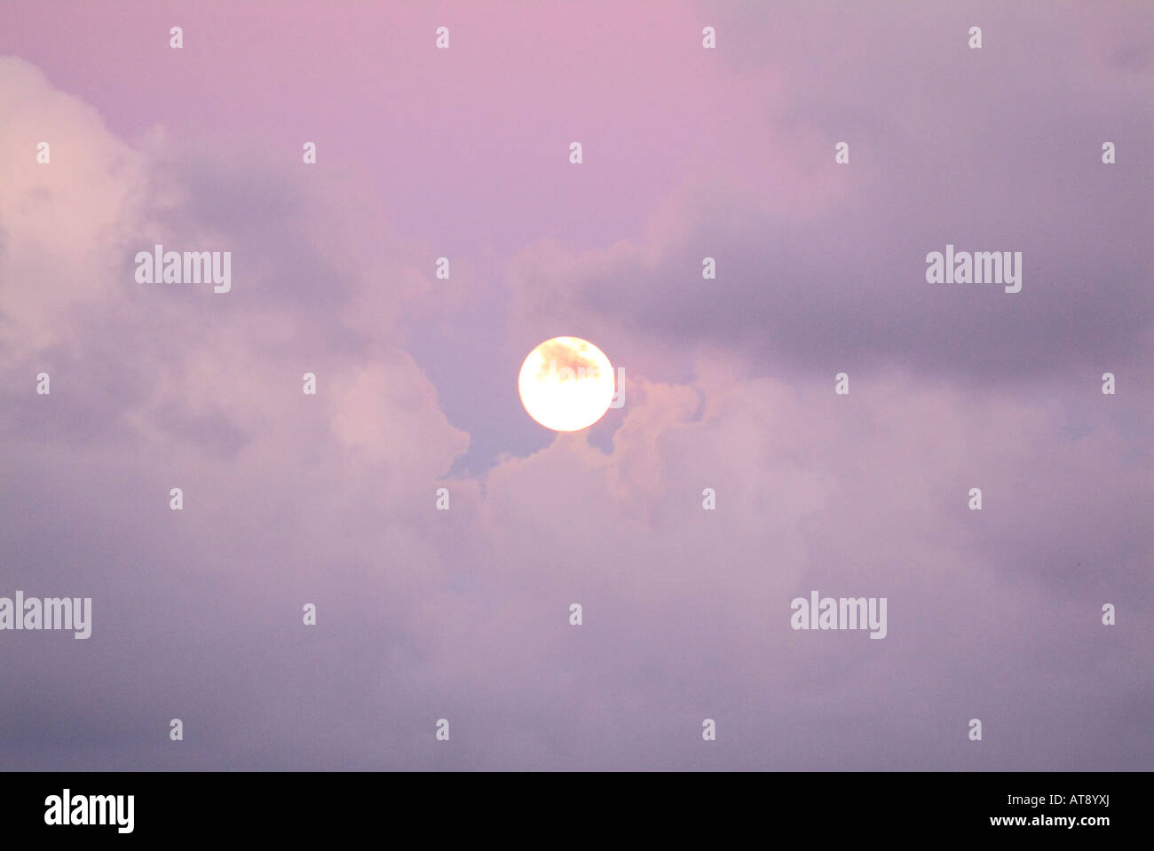 Full moon in a light lavender sky with puffy soft clouds Stock Photo ...