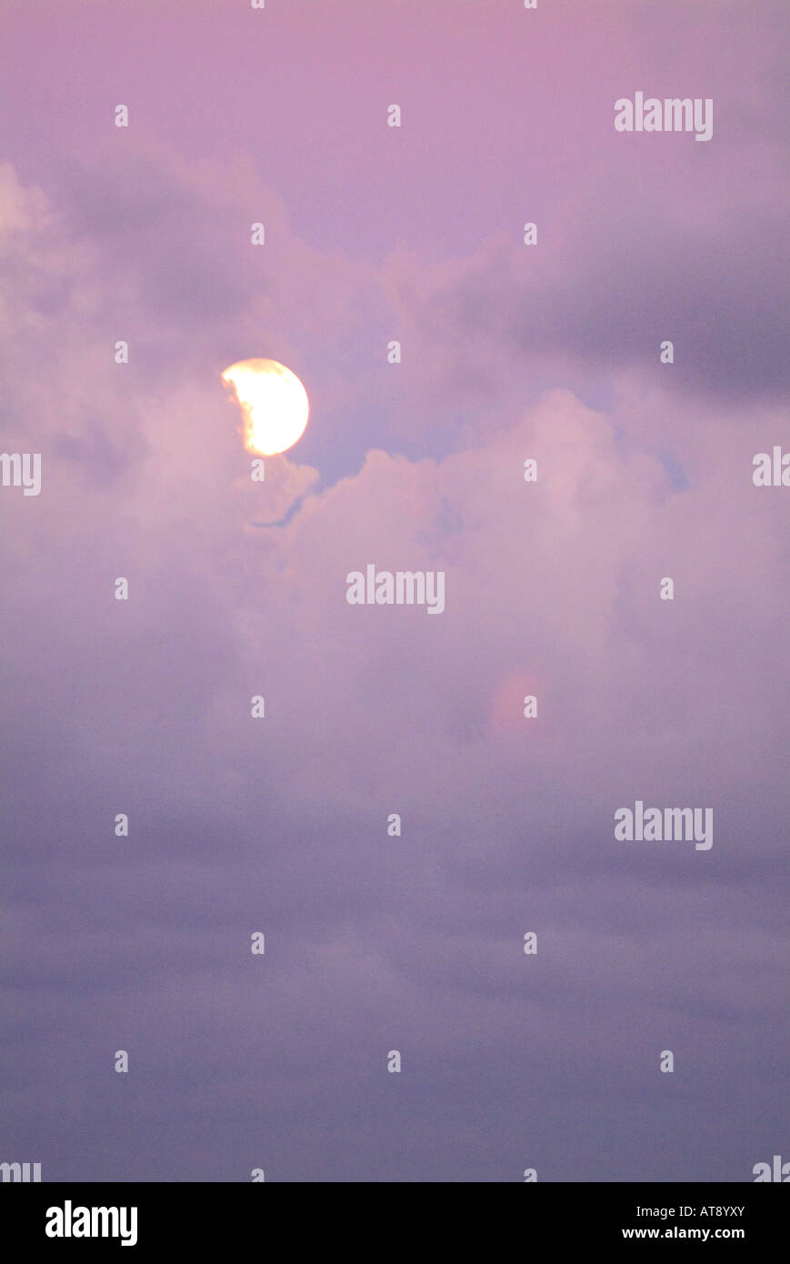 Full moon in a light lavender sky with puffy soft clouds Stock Photo ...