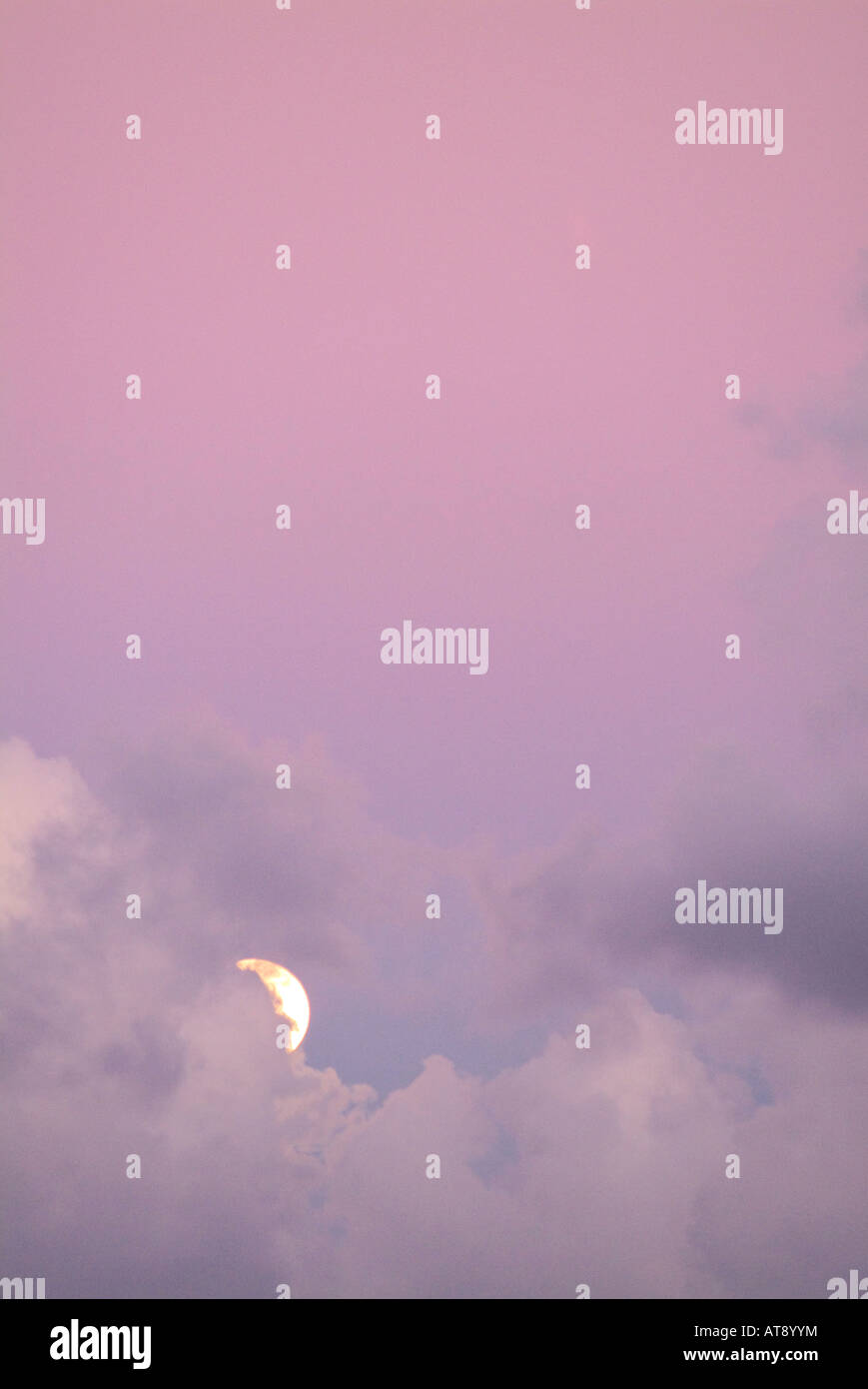 Full moon in a light lavender sky with puffy soft clouds Stock Photo ...