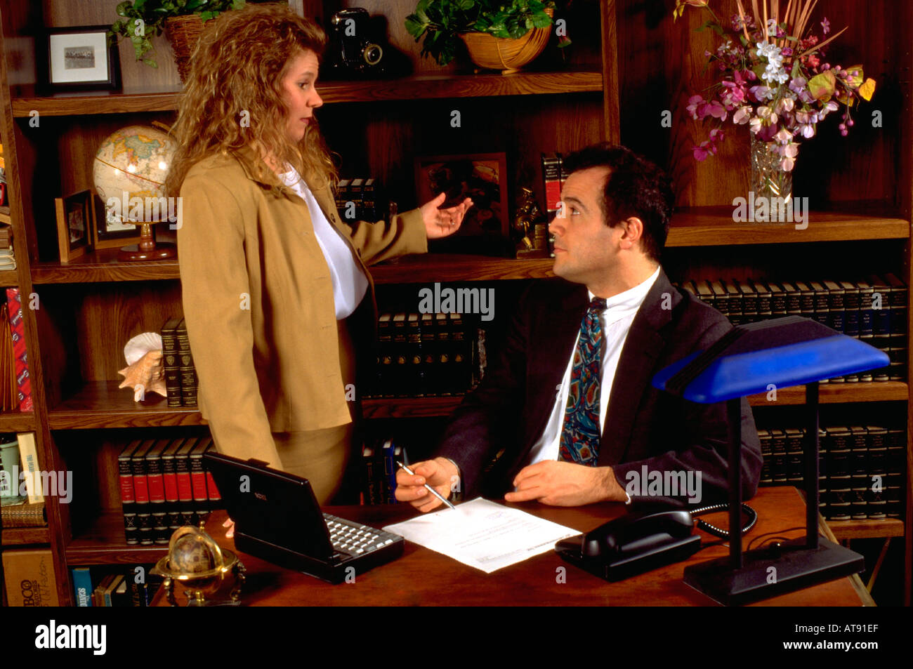 Businessman age 33 consulting with woman business partner age 32 in ...