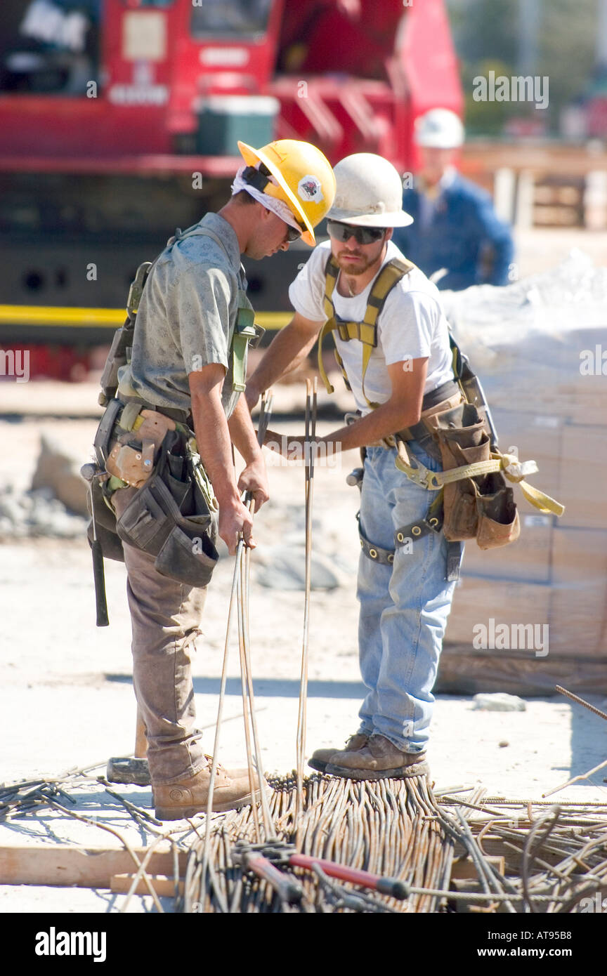 Construction workers with protective clothing and hard hats work on ...