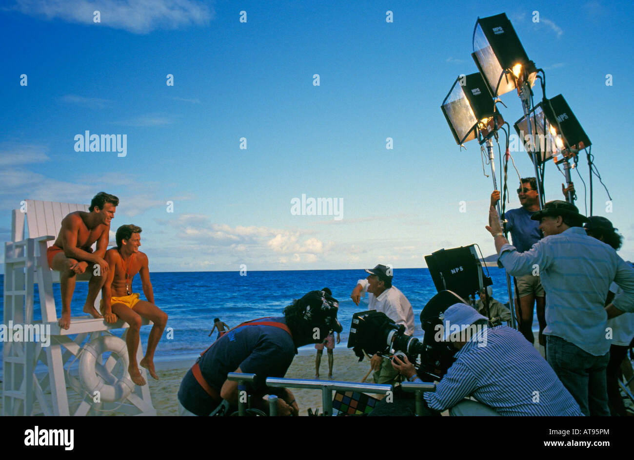 Actors, film crew, and equipment at a beach on Oahu for the shooting of ...