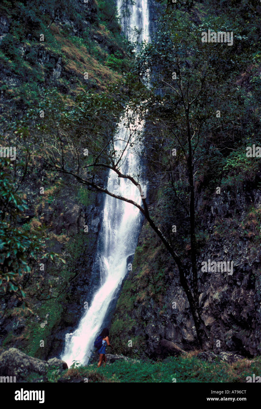 Hiker approaches Halawa Valley Falls, Molokai Stock Photo - Alamy