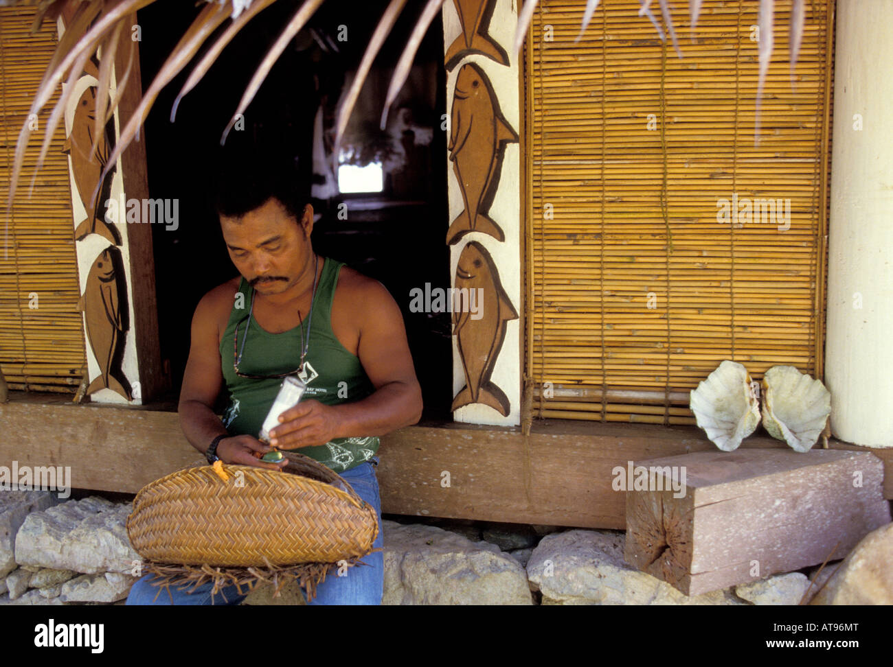 Man preparing betelnut (used for ritual daily chewing) at his house ...