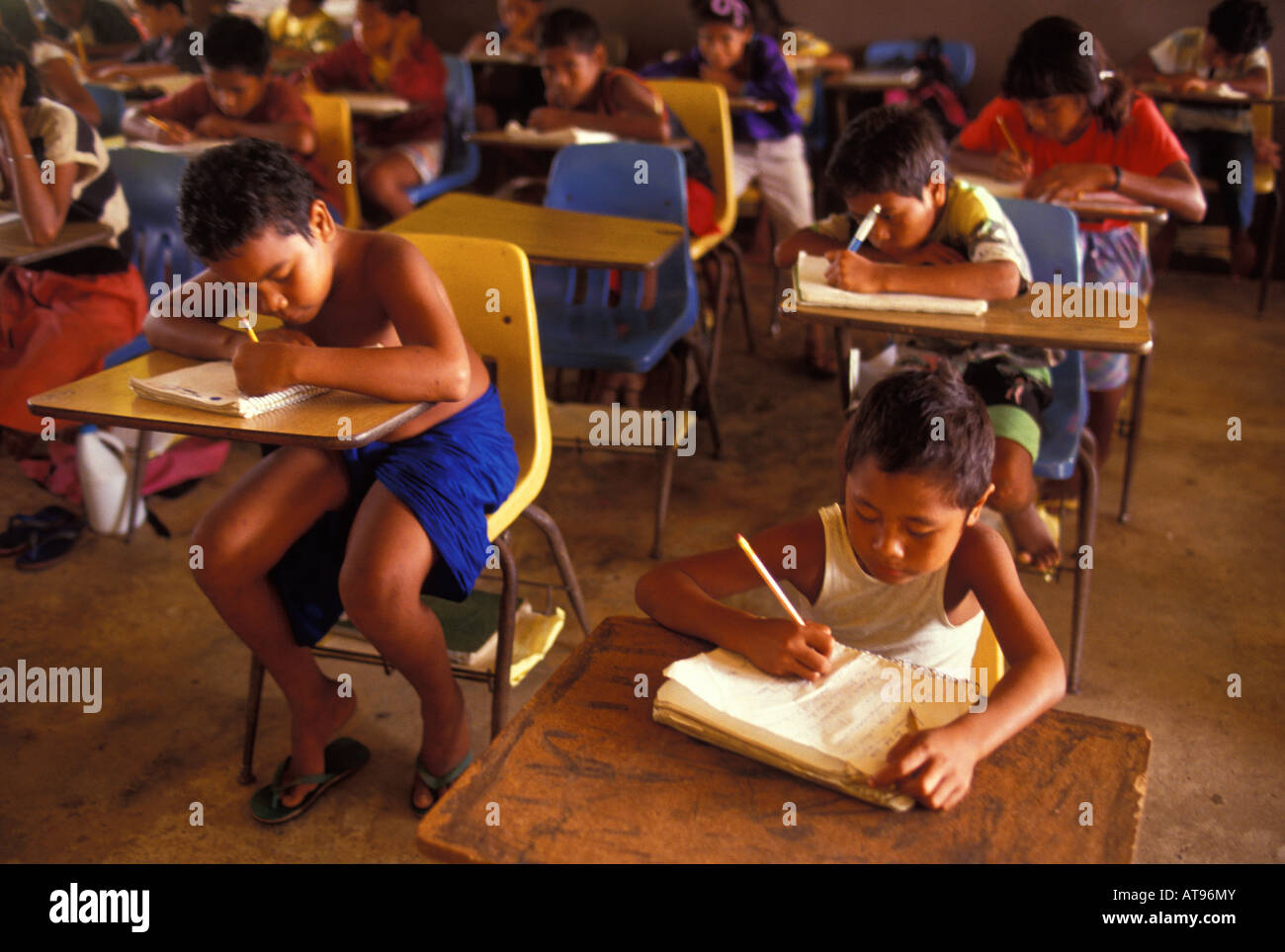Children sitting at their desks and working at school, Yap Micronesia ...