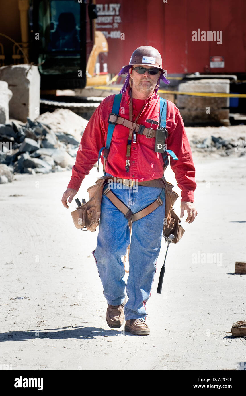 Construction workers with protective clothing and hard hats work on ...