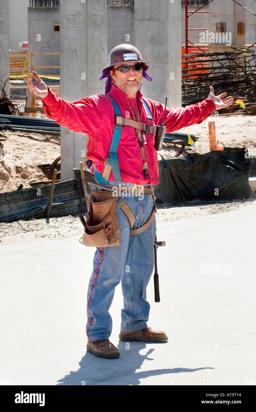 Construction workers with protective clothing and hard hats work on ...