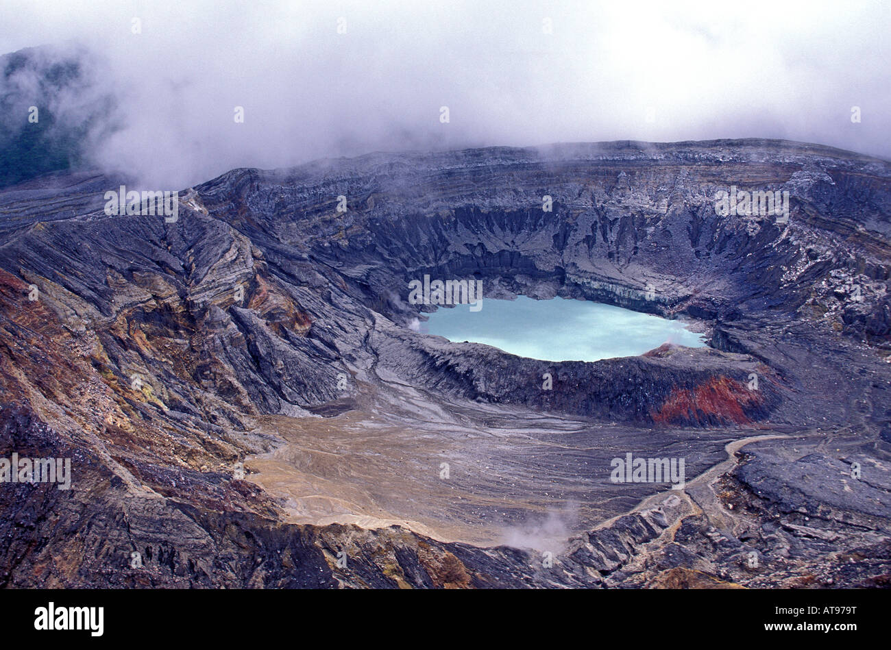 Unusual shot of blue lake set in middle of a dormant volcano surrounded ...