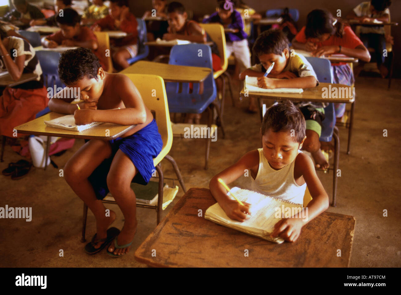 Children studying in school, writing in notebook, in Yap, Micronesia ...