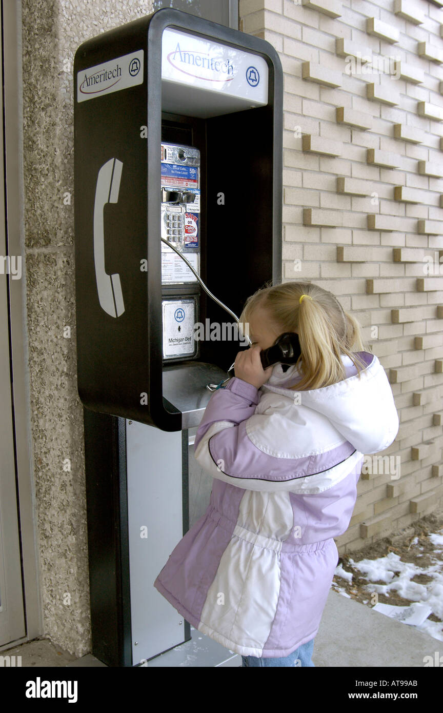 Six Year Old Girl Talks on Pay Telephone Stock Photo - Alamy