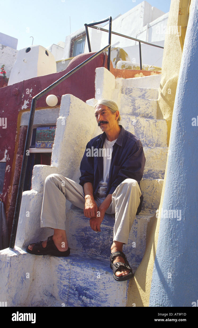 greek man sitting on stairs of a house Stock Photo - Alamy