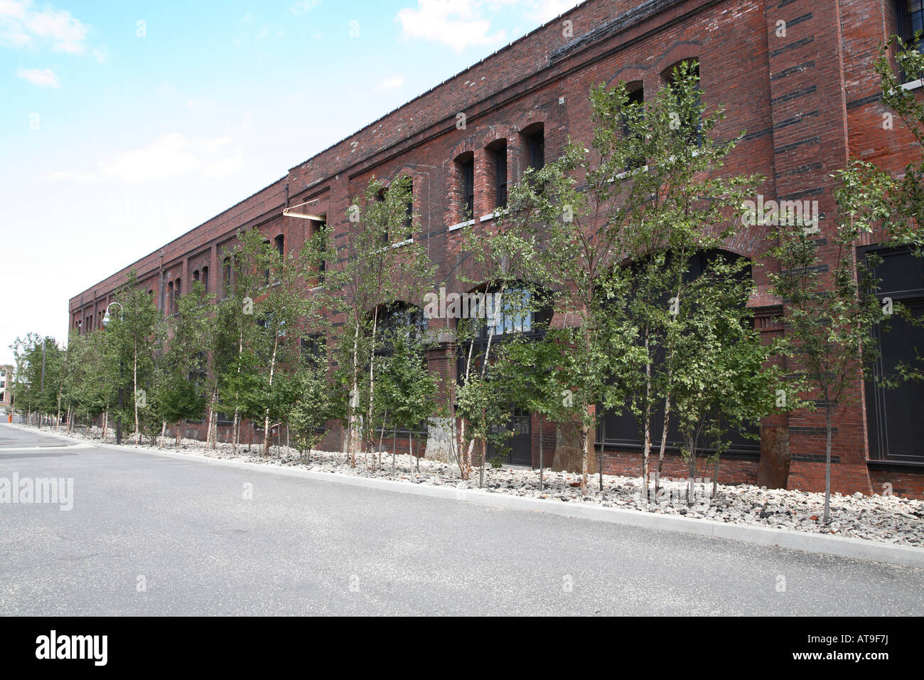 Brick two story building with bays of roman arches filled with many ...