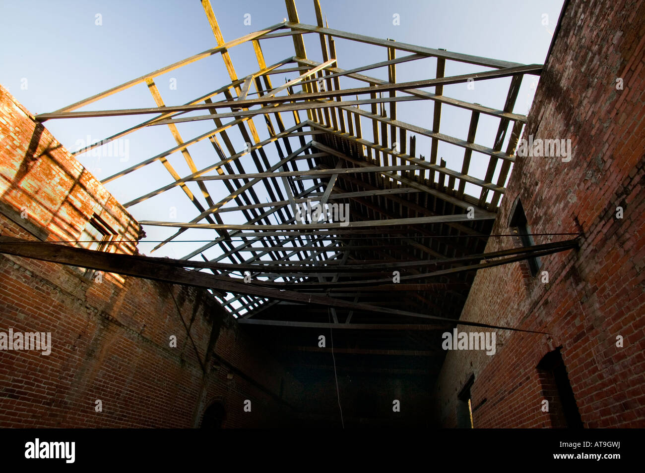 Collapsing roof exposing girders rafters old red brick grain storage ...