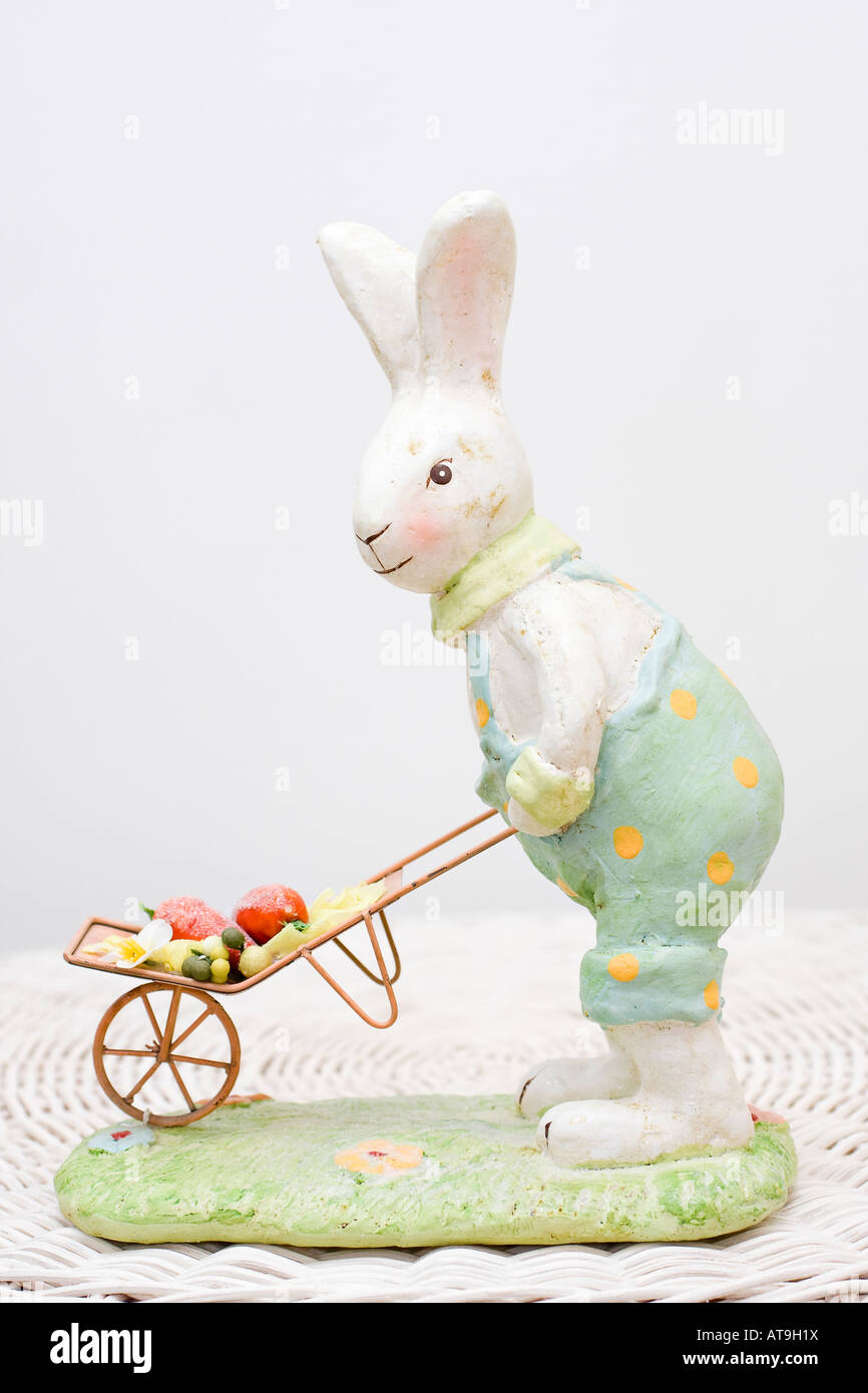 A ceramic model of a cute bunny rabbit pushing a wheelbarrow Stock ...