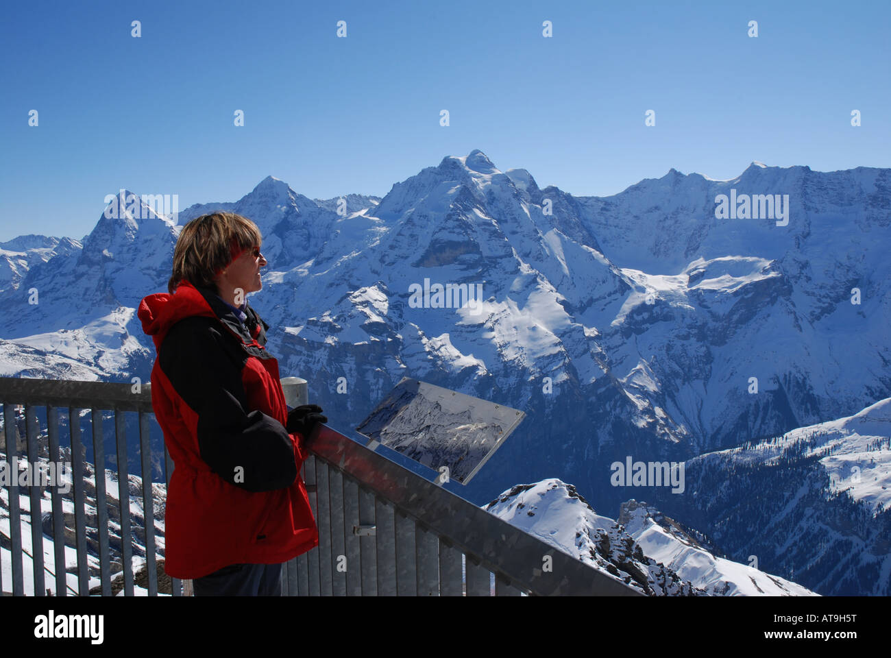 Tourist viewing Bernese alps in winter from Schilthorn, Switzerland ...