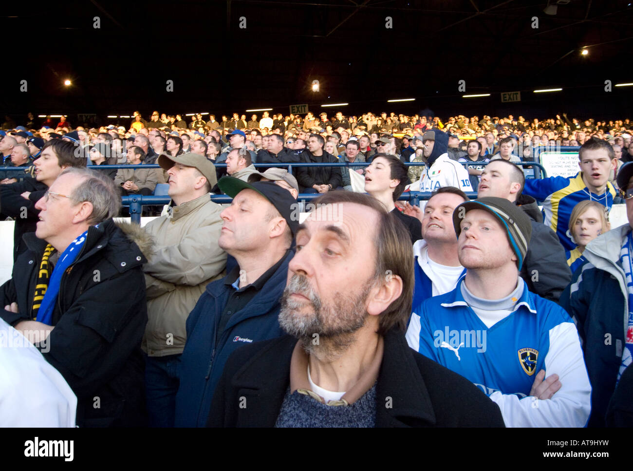 Faces in a football crowd standing all looking in the same direction ...