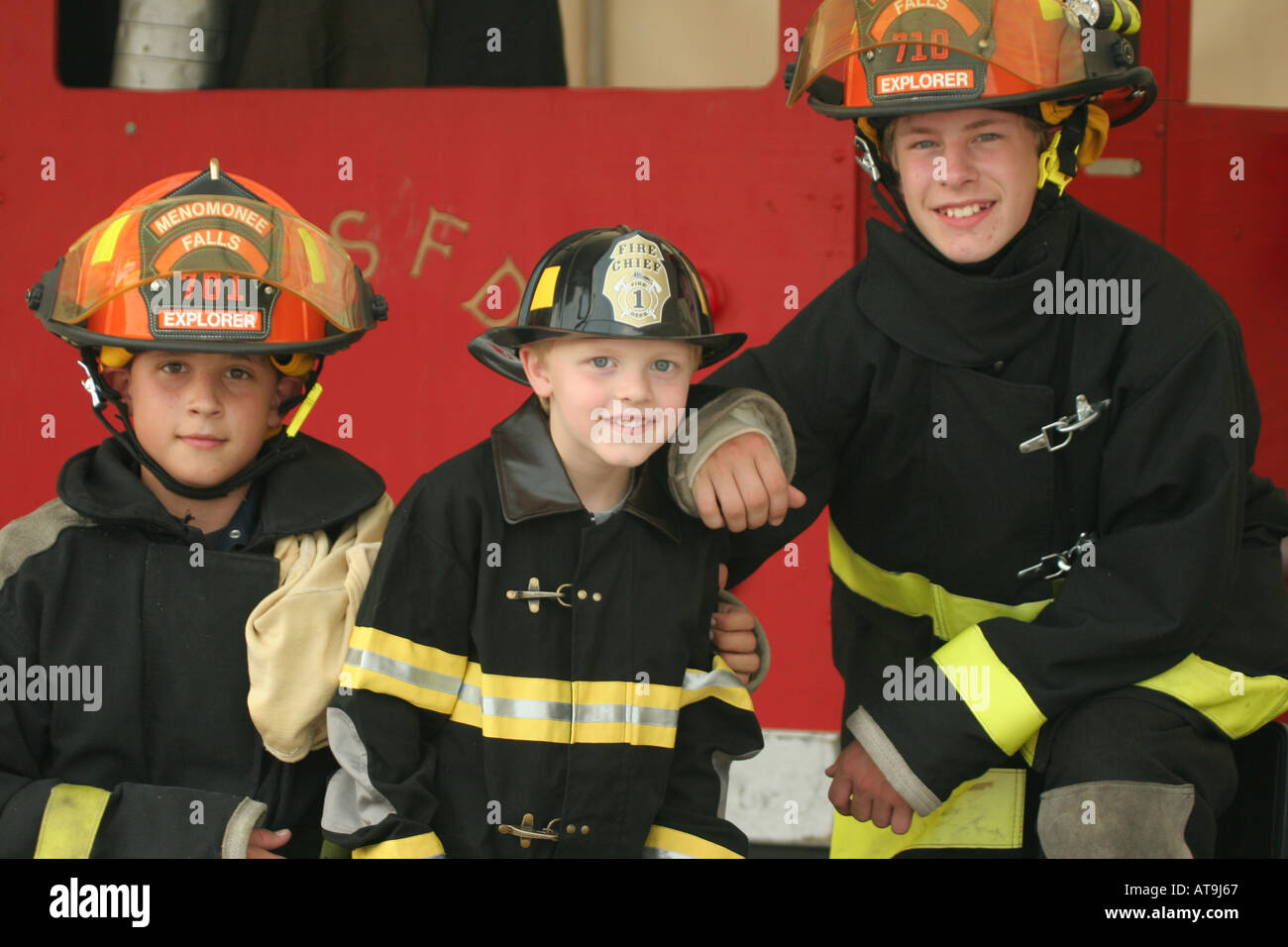 Three future fire fighters in uniform at a Fire Safety Fair Stock Photo ...