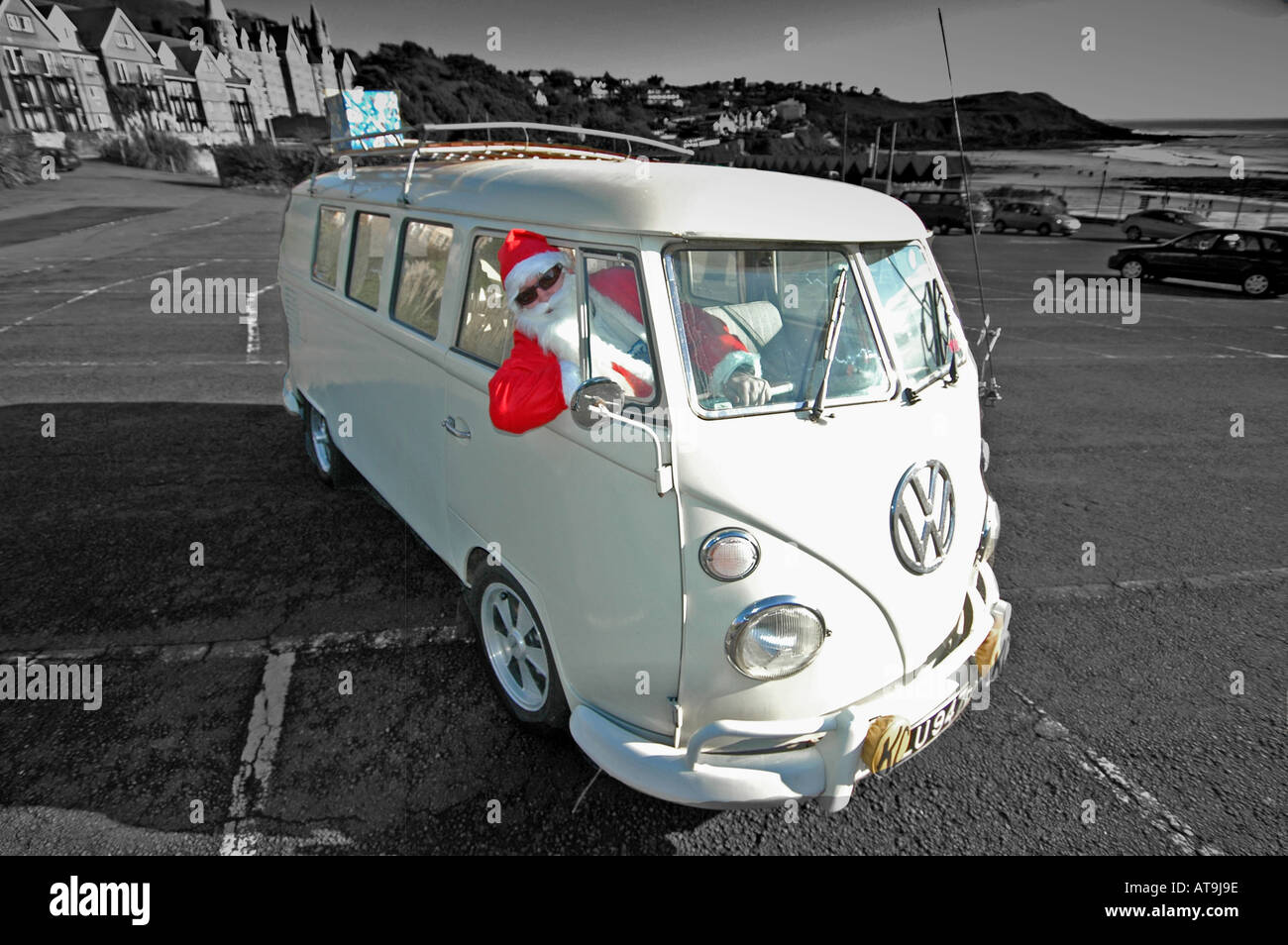 Santa driving a VW split screen camper van by the beach Stock Photo - Alamy