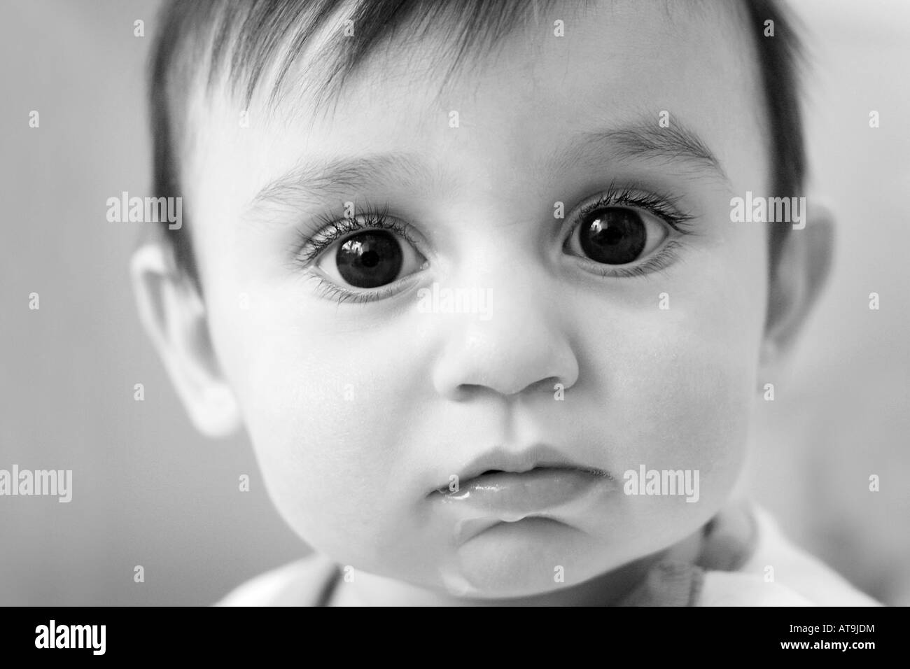 close up black and white of baby with big eyes drooling Stock Photo - Alamy