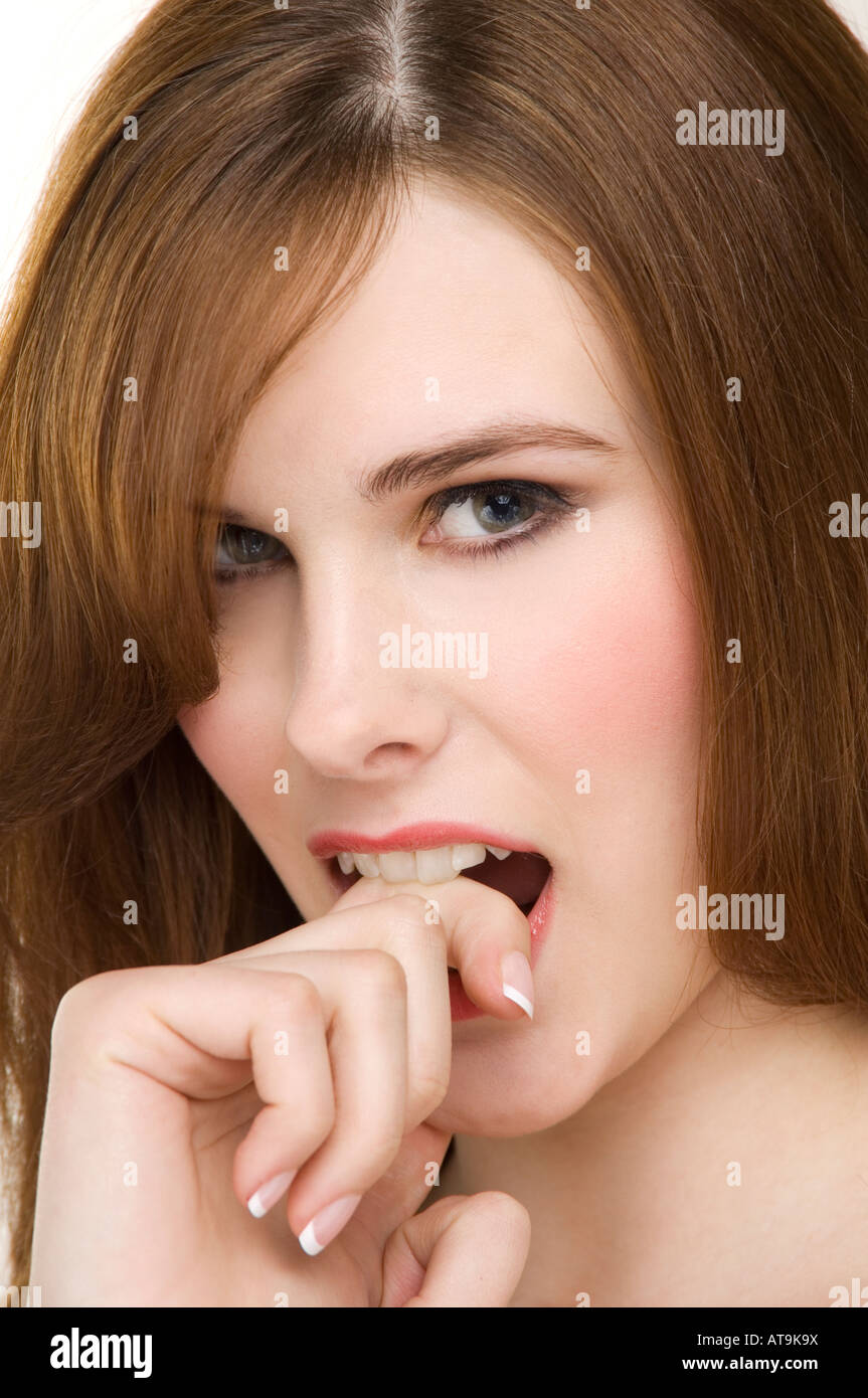 woman biting her finger expression Stock Photo - Alamy