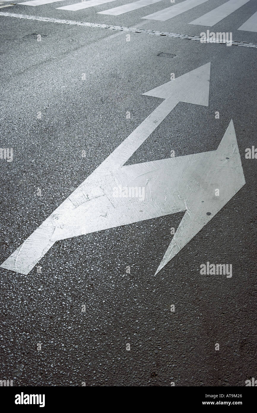 White arrows on road indicating direction for traffic to follow Stock ...