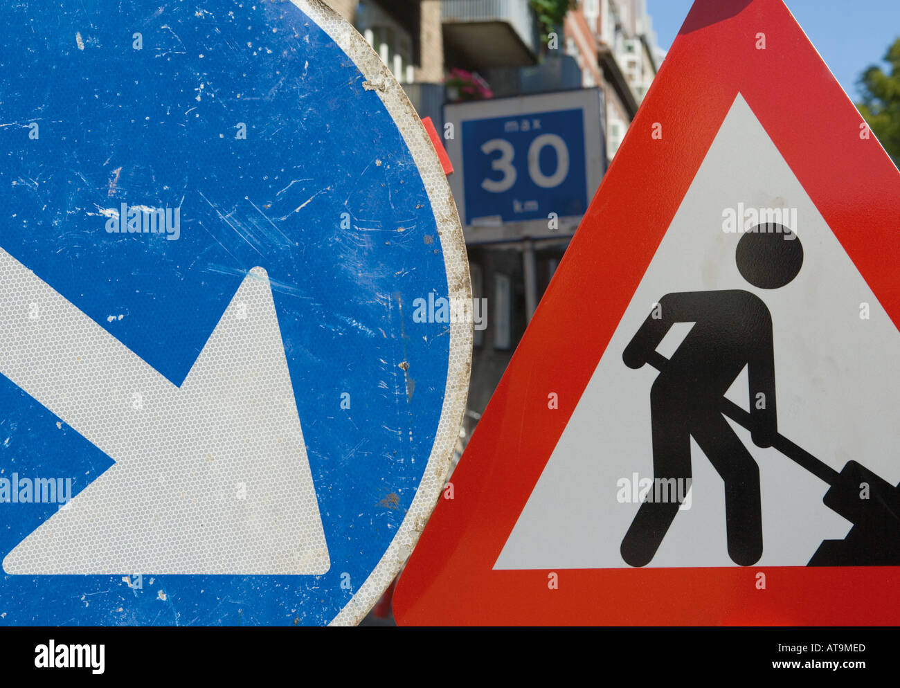 Move in This Direction Men at Work and 30 kilometers per hour signs in ...