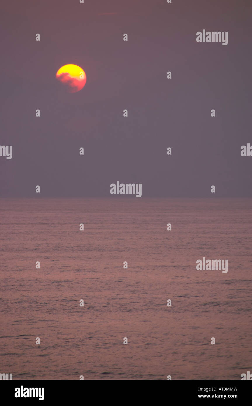 Clouds in the marine layer creep across the sunset in the Atlantic ...