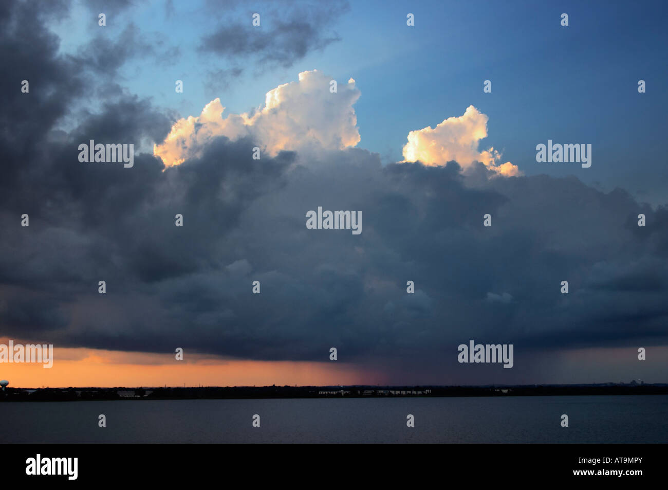 Storm clouds unleash a rain column over the banks of the Delaware River ...