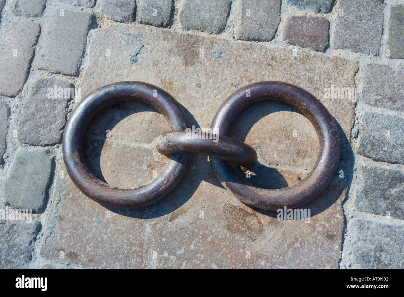 Two metal mooring rings on wharf surrounded by cobble stones Stock ...