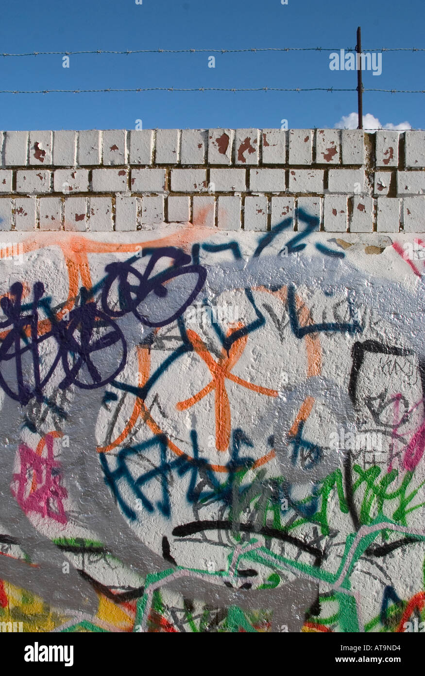 Colourful graffiti and barbed wire from Thames Path. North Greenwich ...