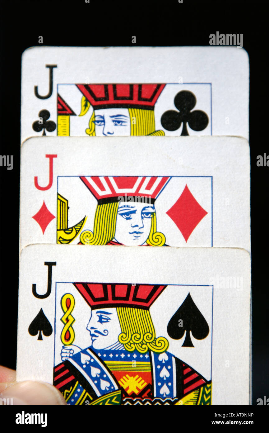 Three jacks in a hand of cards Stock Photo - Alamy